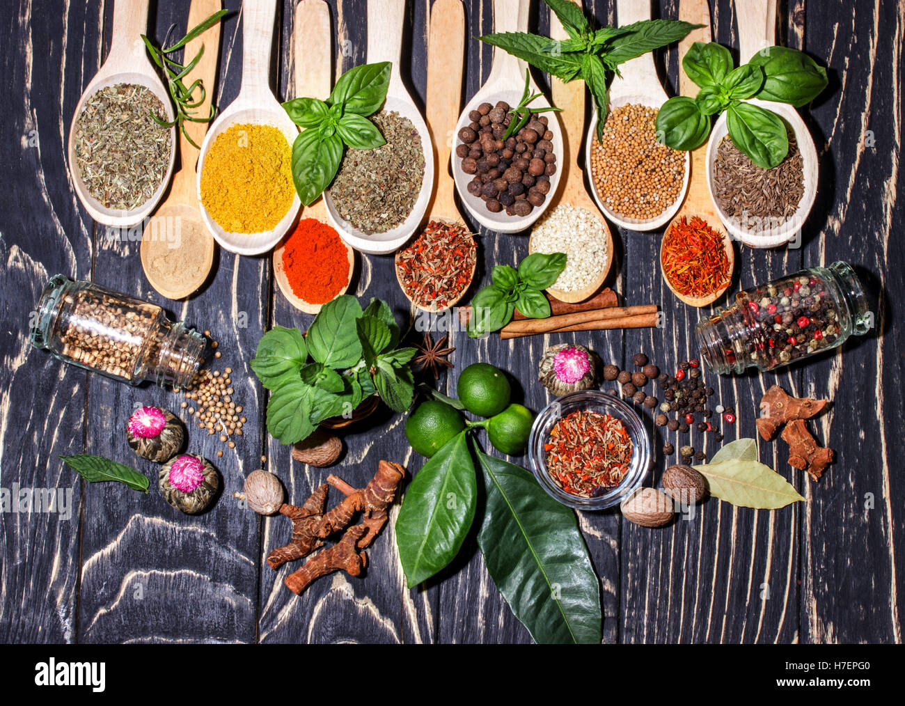 Colorful aromatic spices and herbs on an old oak wooden brown ...