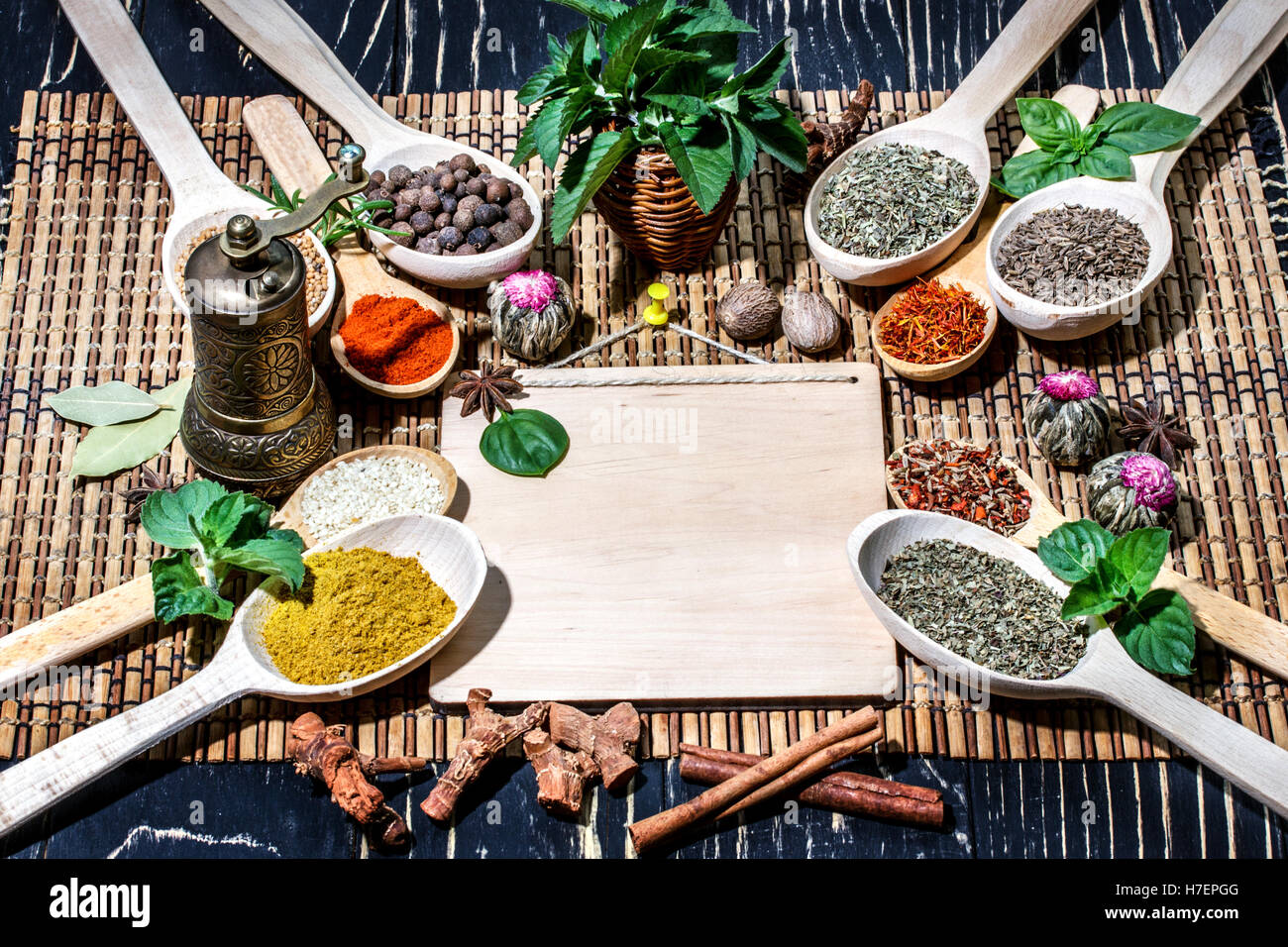 Colorful aromatic spices and herbs on an old oak wooden brown ...