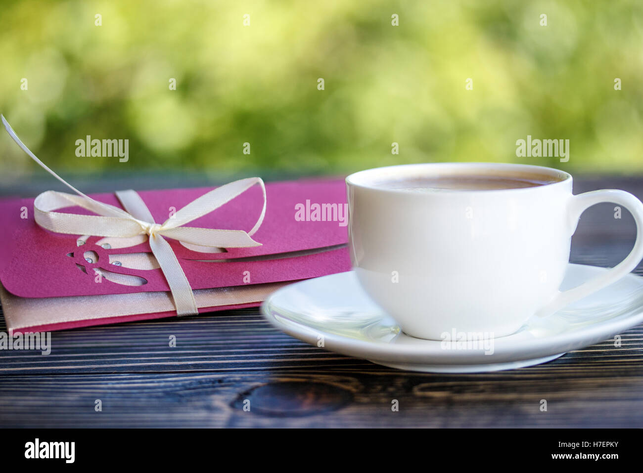 cup of coffee and an envelope on wooden background outdoors Stock Photo ...