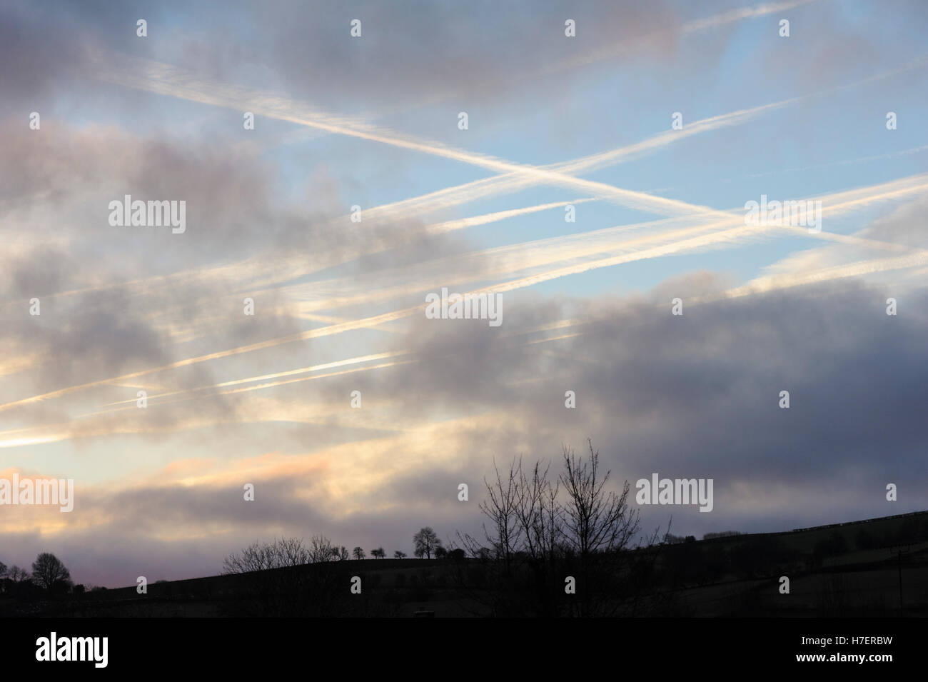 Crossing condensation trails formed by aircraft above the Welsh border ...