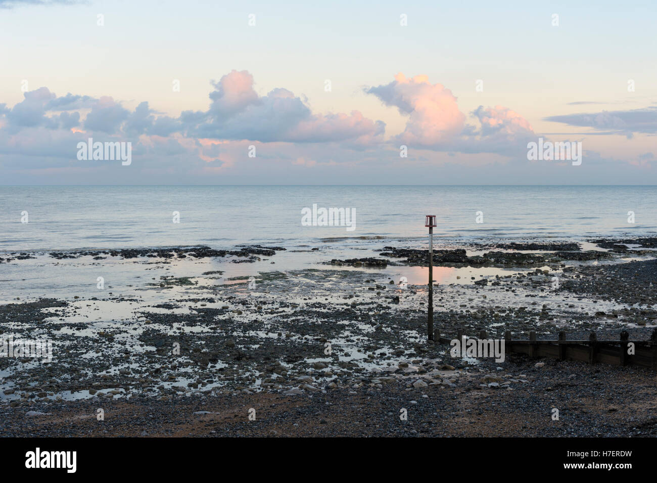 Sunset over shingle beach with breakwater and marker buoy at Kingsdown ...
