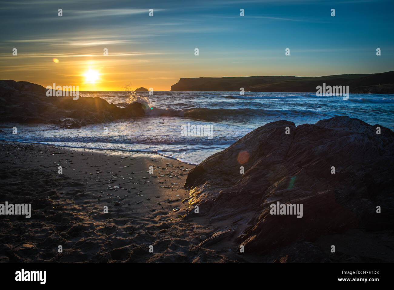 Setting sun at Polzeath beach, a noted surfers beach in Cornwall, UK ...