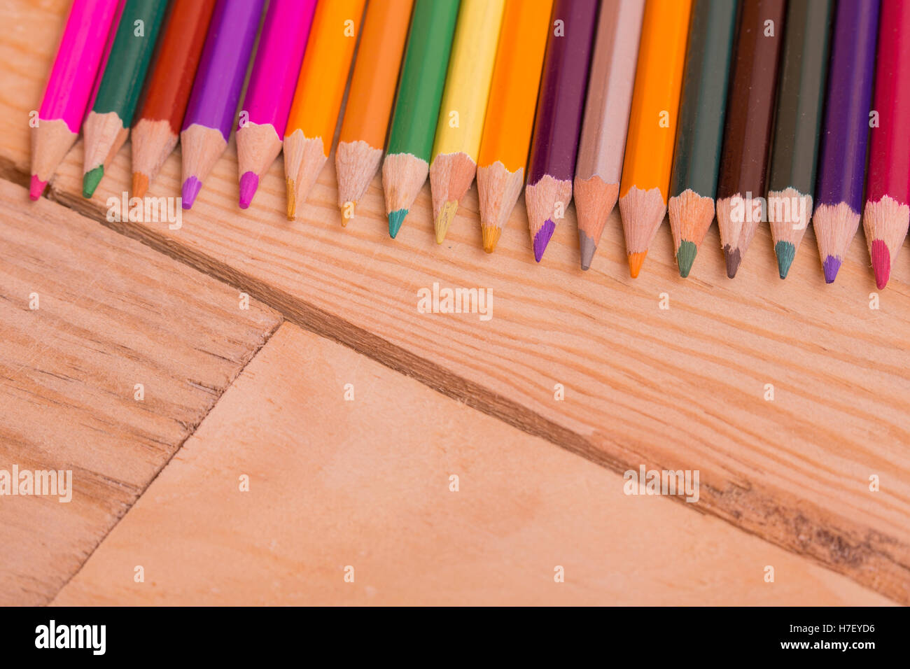 Wooden colorful pencils, on wooden table Stock Photo - Alamy