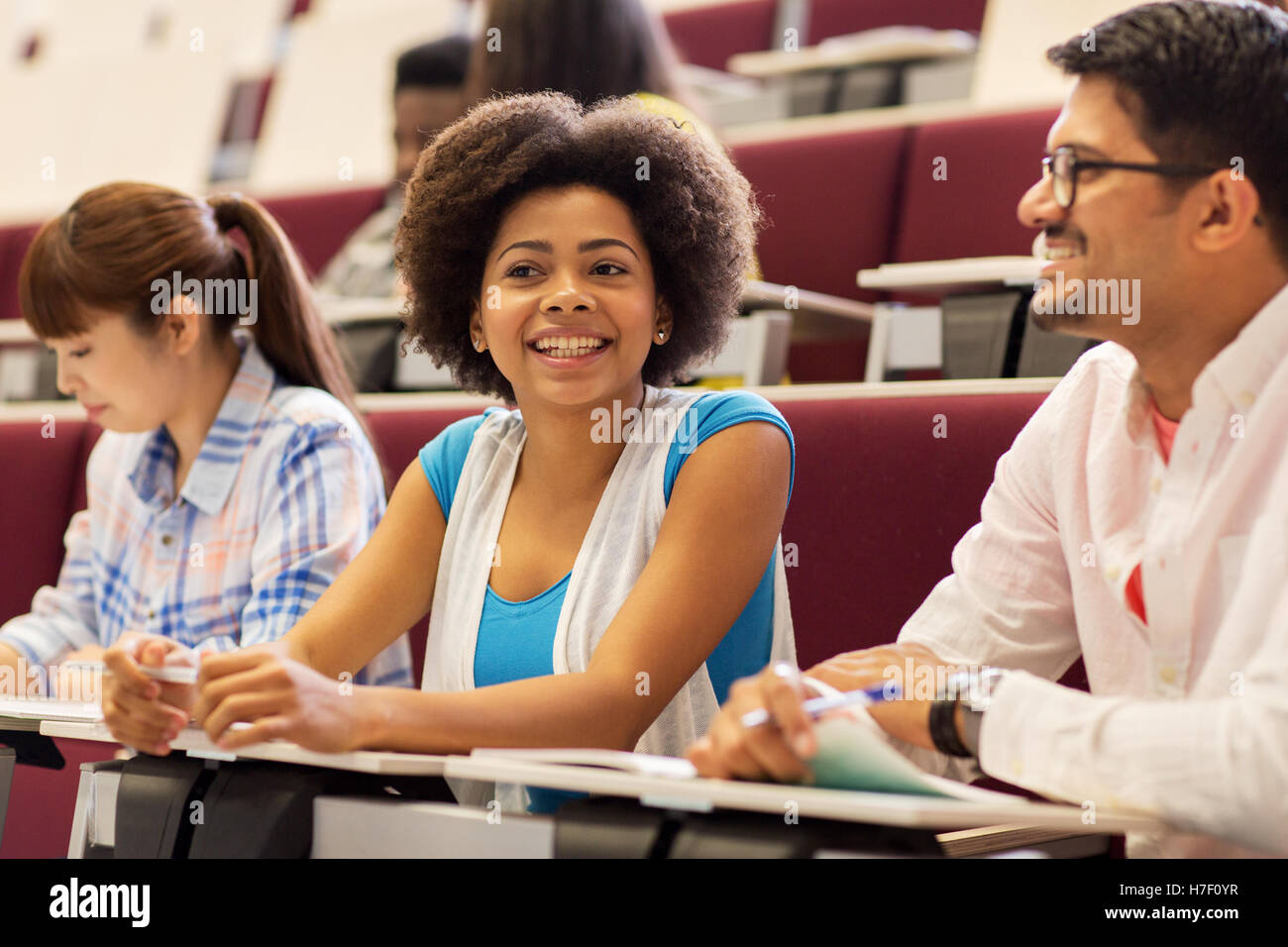group of students with notebooks in lecture hall Stock Photo - Alamy