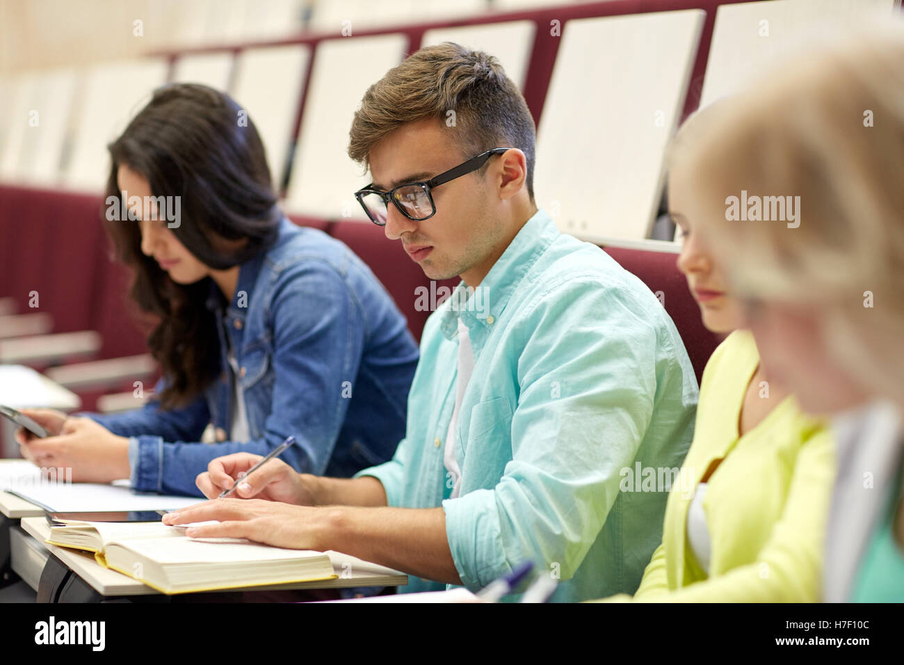 group of students with books writing at lecture Stock Photo - Alamy