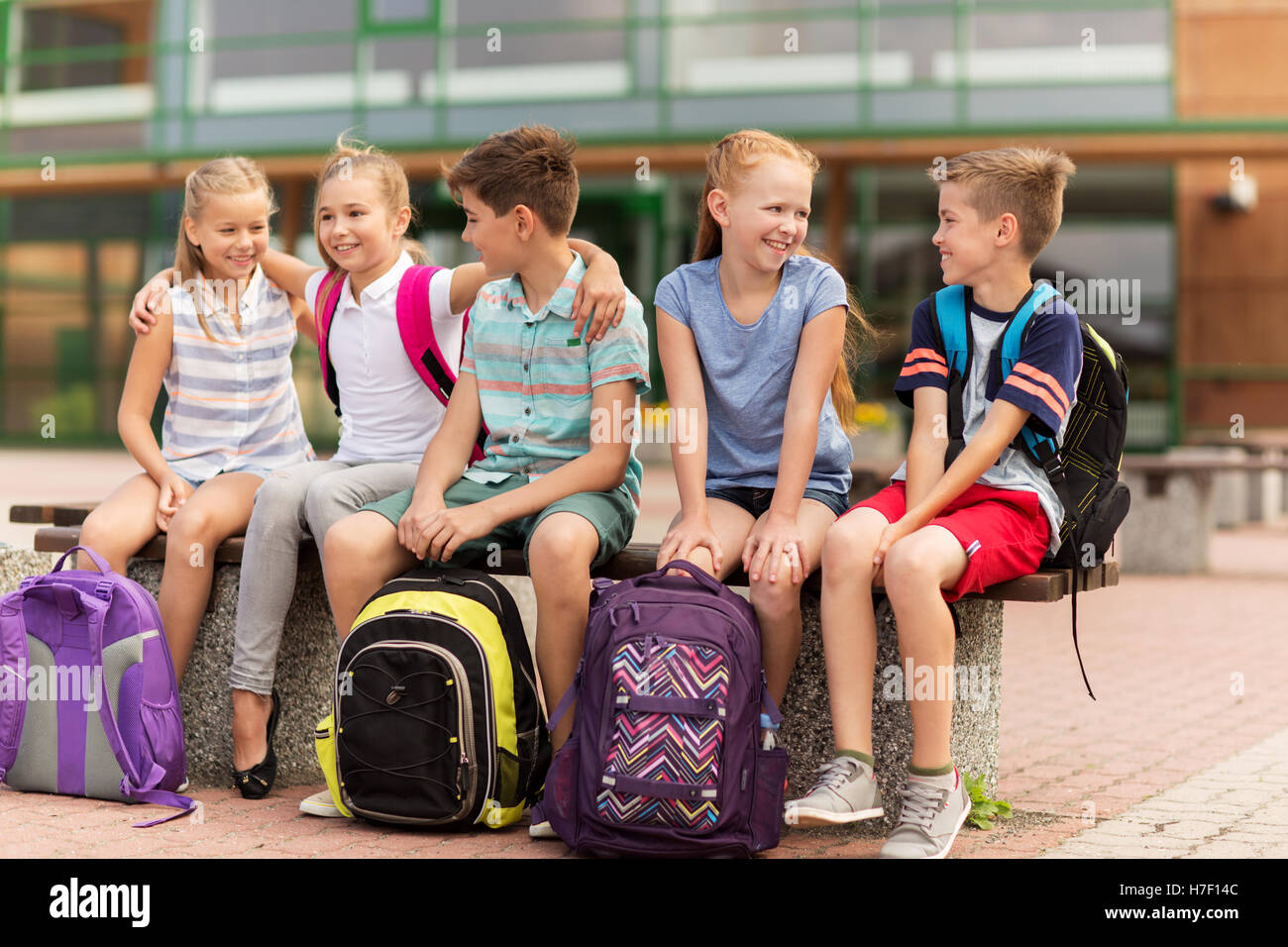 group of happy elementary school students talking Stock Photo - Alamy