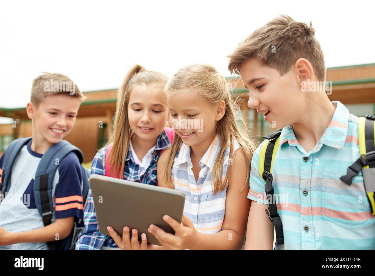 group of happy elementary school students talking Stock Photo - Alamy