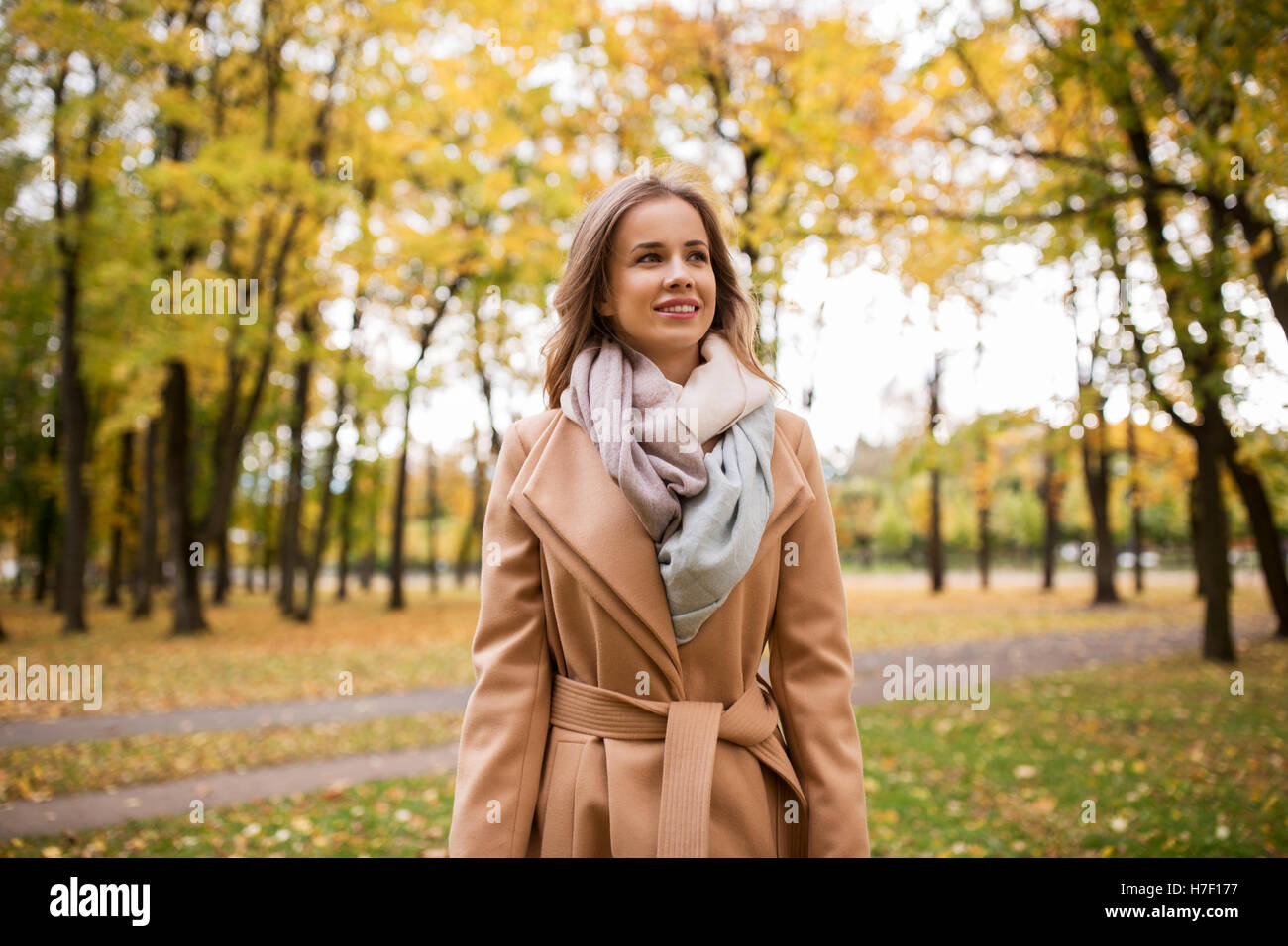 beautiful happy young woman walking in autumn park Stock Photo - Alamy
