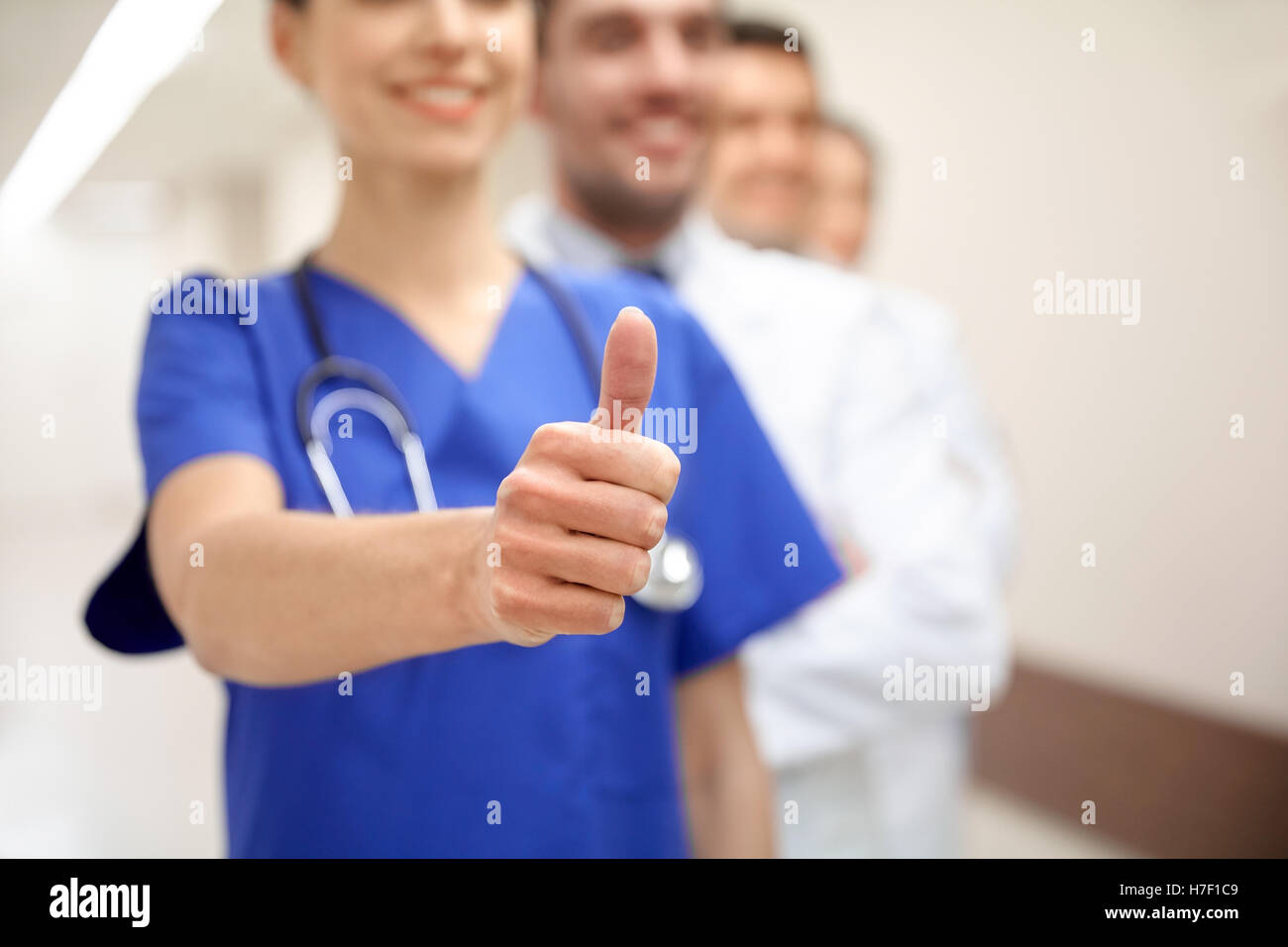close up of doctors at hospital showing thumbs Stock Photo - Alamy