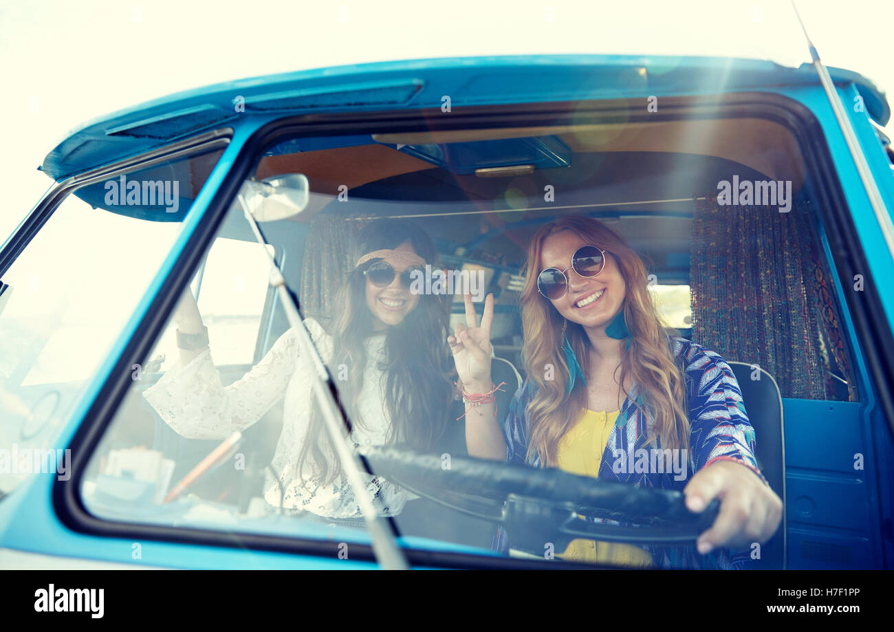 smiling young hippie women driving minivan car Stock Photo - Alamy