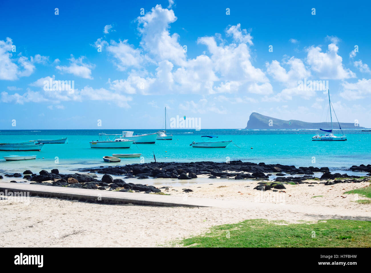 Boats moored in lagoon of Cap Malheureux with the island of Coin de ...