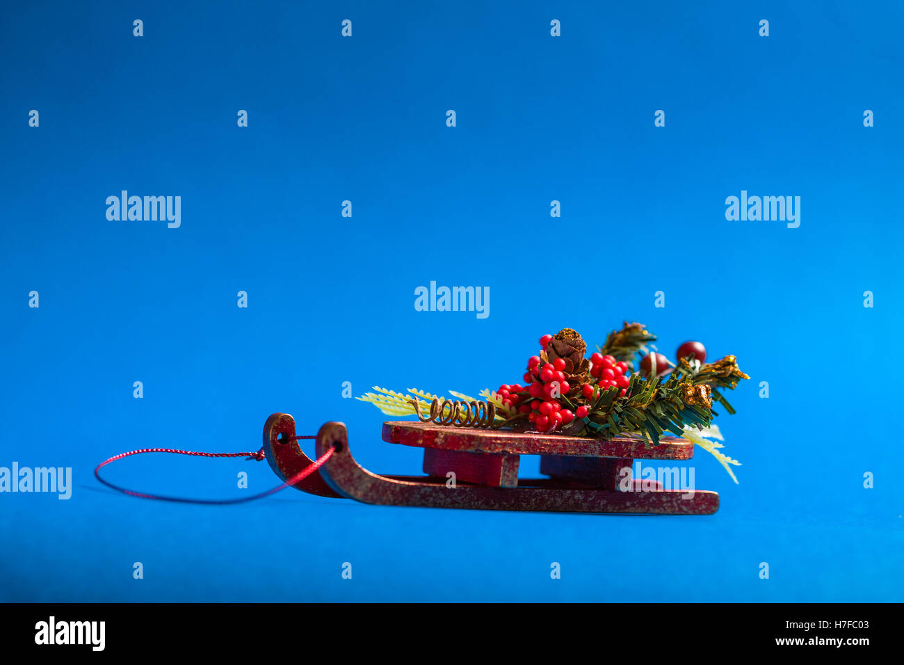 Christmas card with decorative sledge standing on blue background Stock ...