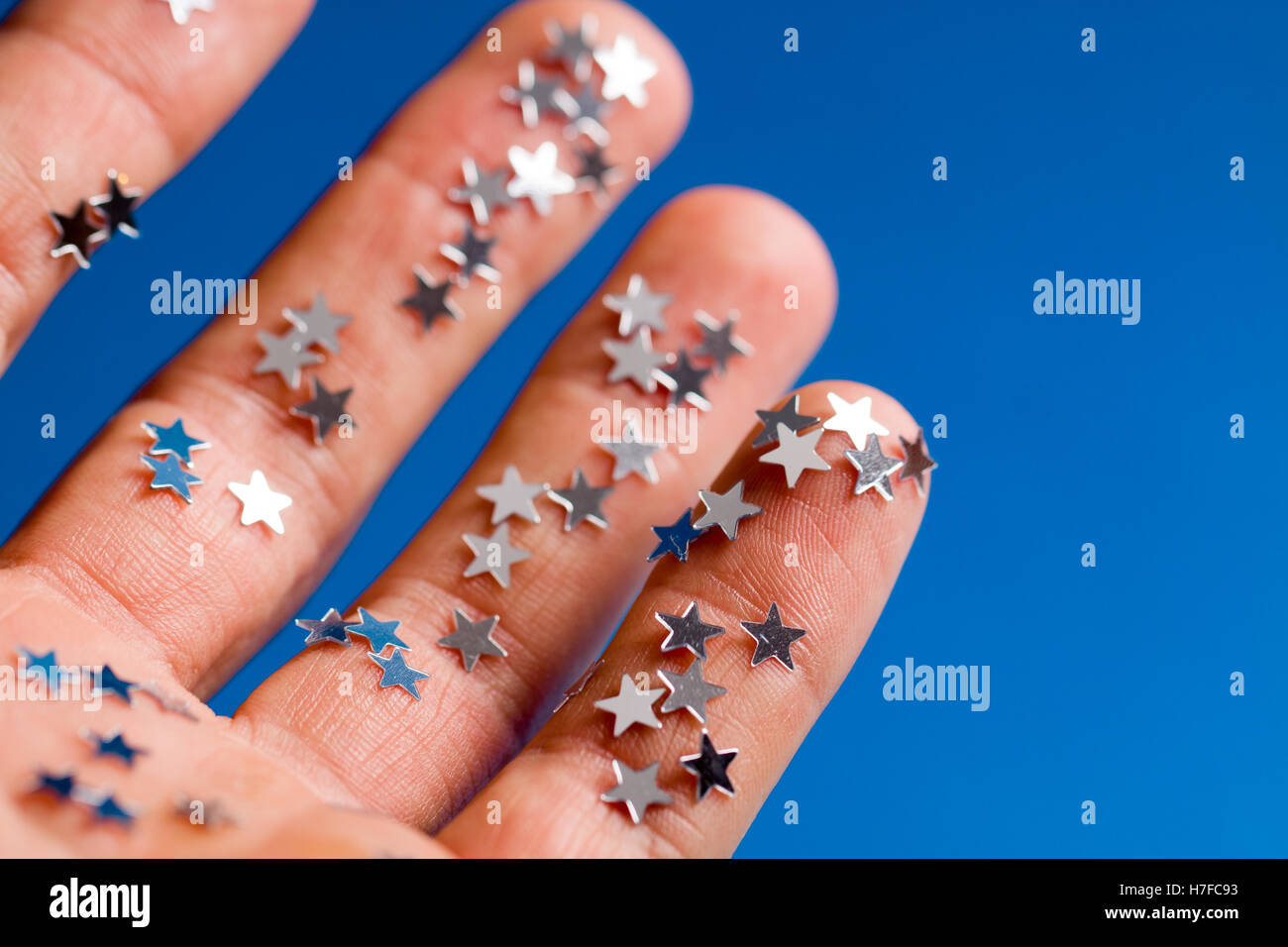 Small glowing stars on hand Stock Photo - Alamy