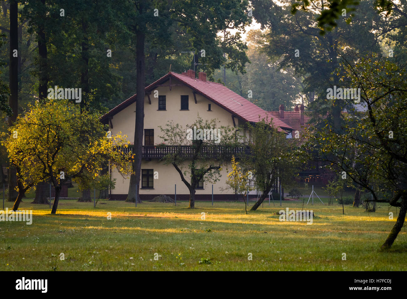 Foresters house building among surrounding trees of forest and orchard ...