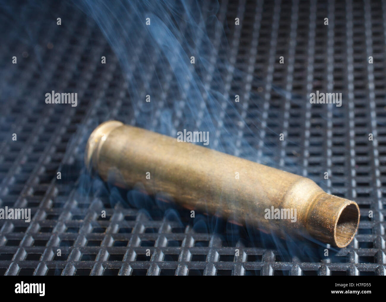Rifle casing that is still hot and surrounded by smoke Stock Photo - Alamy