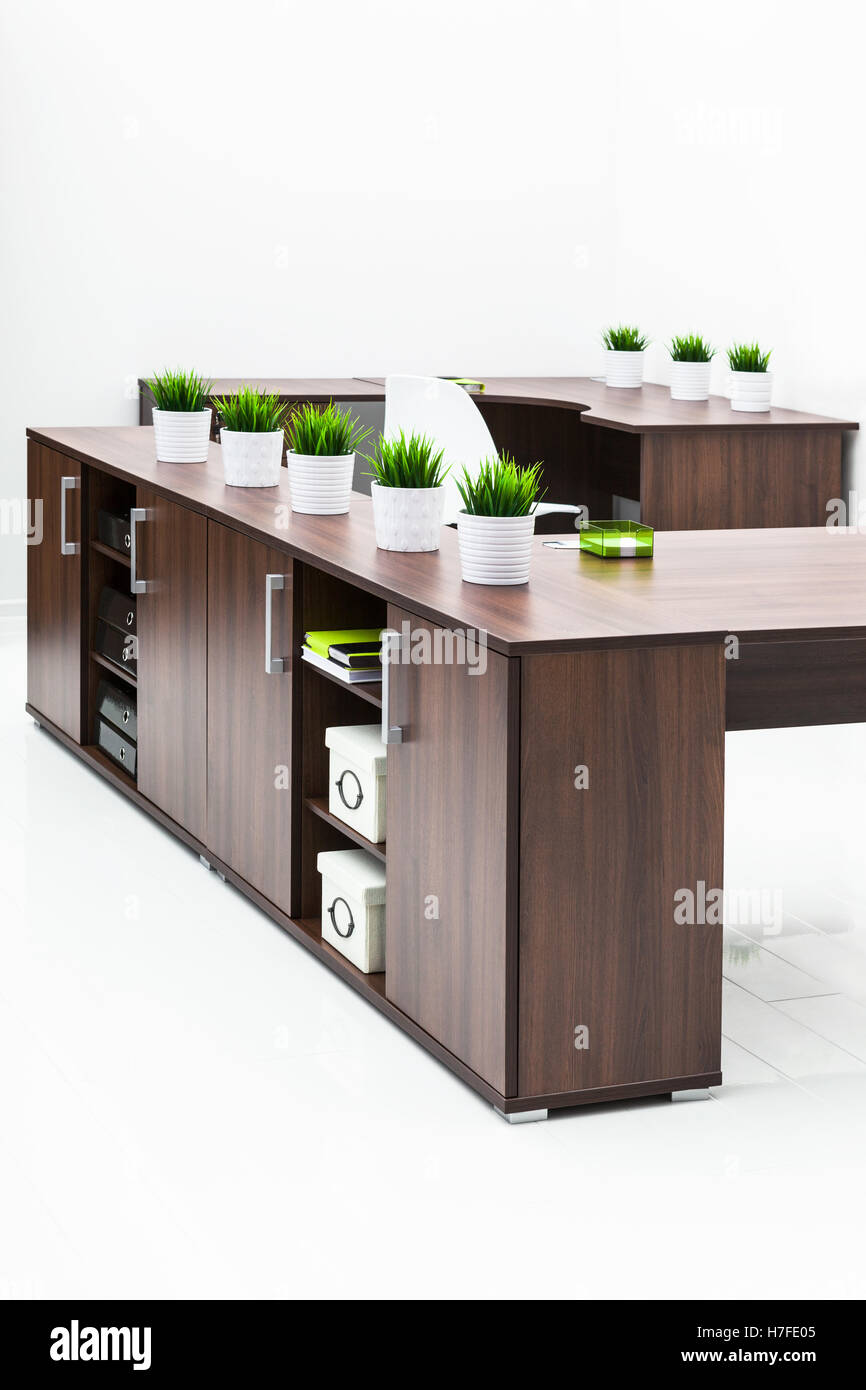 tables and bookcase of a white wall Stock Photo - Alamy