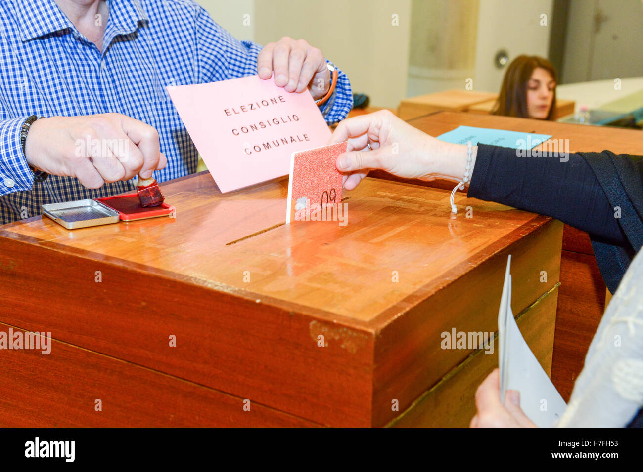 Lugano, Switzerland - 11 april 2016: Hand putting a voting ballot in a ...