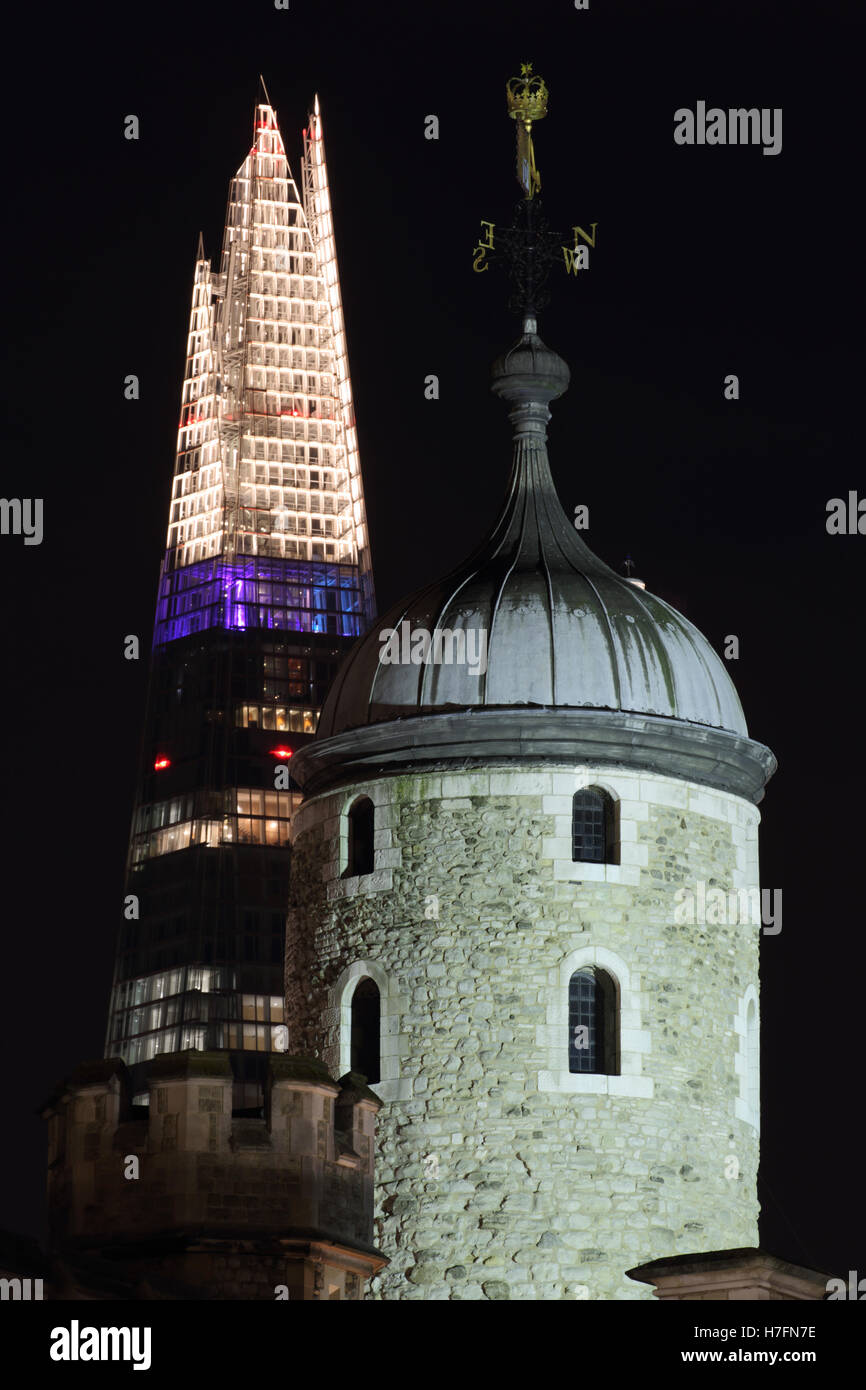 The round tower at the Tower of London and The Shard at night showing ...