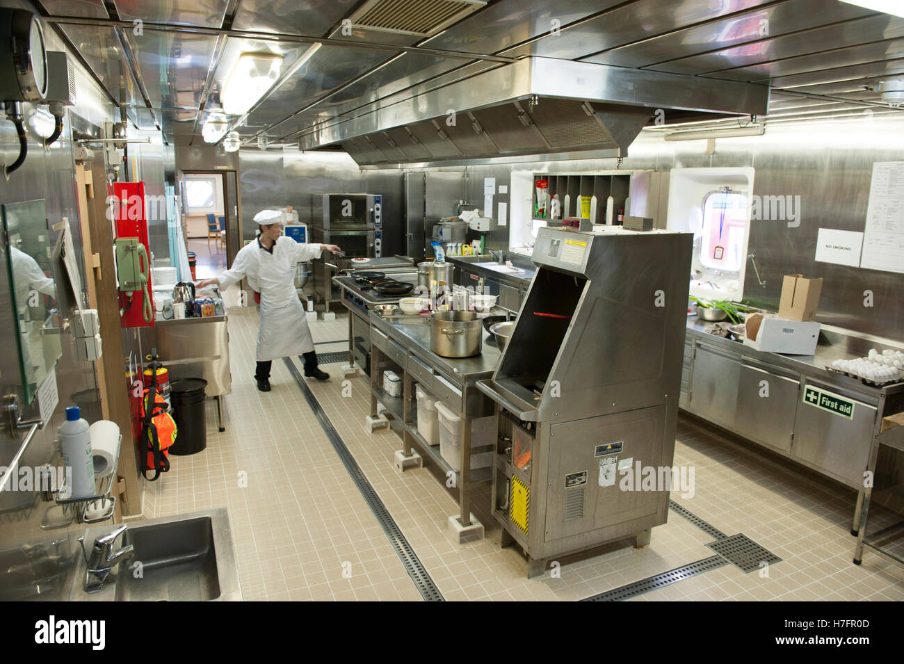Galley Kitchen Of Container Ship With Crew Chef Smiling