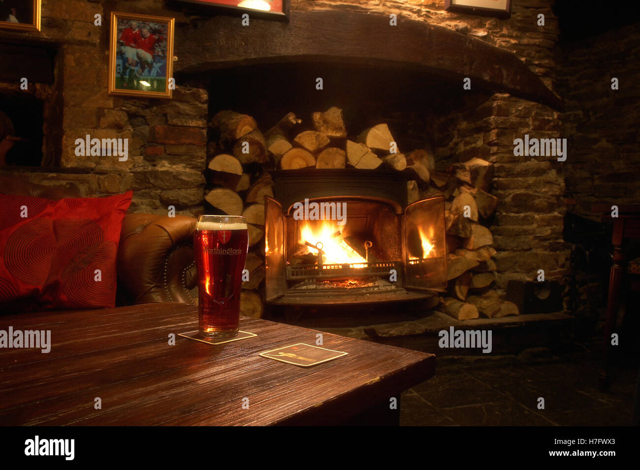 A pint of beer in a cosy pub with a log burner in the UK Stock Photo ...