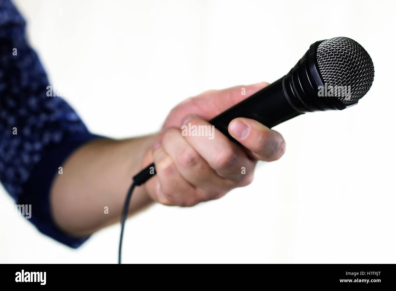 microphone on stage hand hold Stock Photo - Alamy