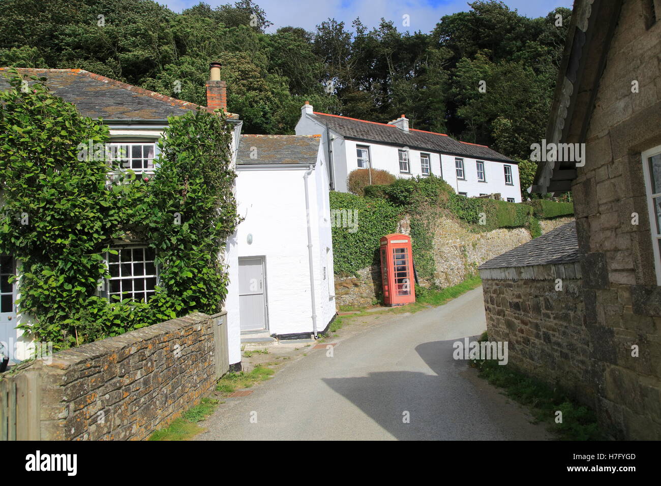 Traditional red telephone box and whitewashed cottages, village of ...