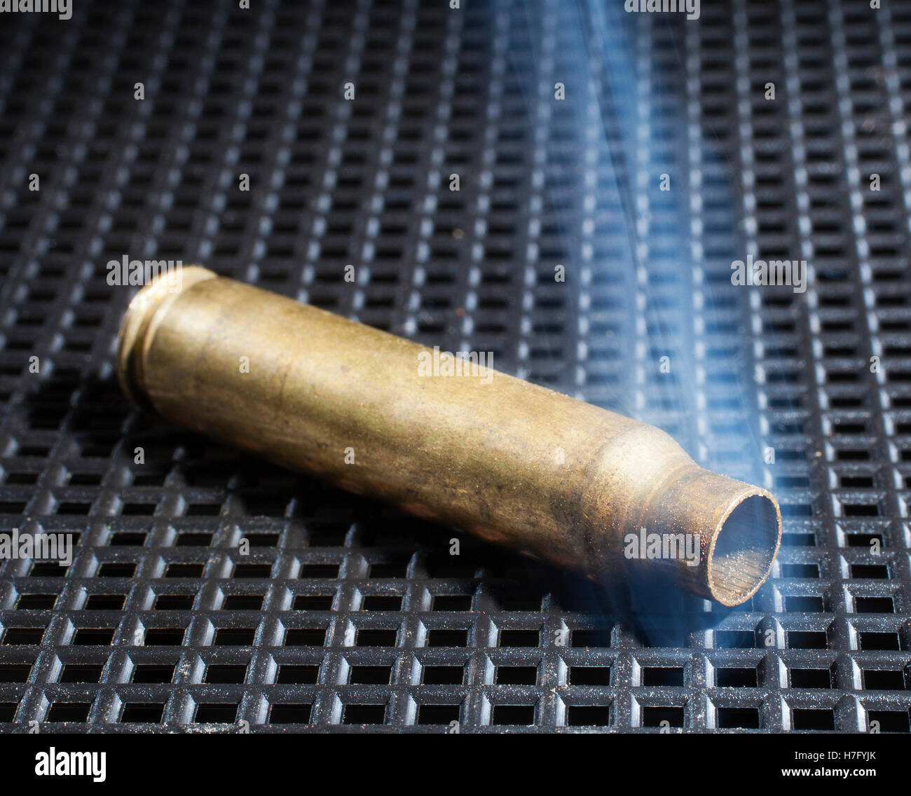 Rifle casing that has just been shot and is smoking Stock Photo - Alamy