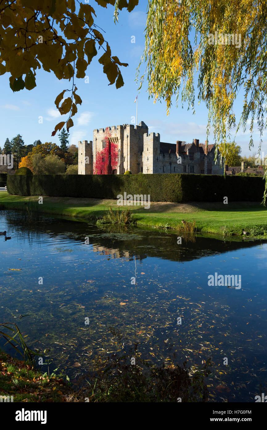 Hever Castle & moat, former home of Anne Boleyn, clad with red autumnal ...