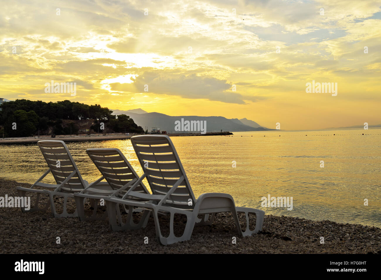 Abandoned sunbeds on beach Stock Photo - Alamy