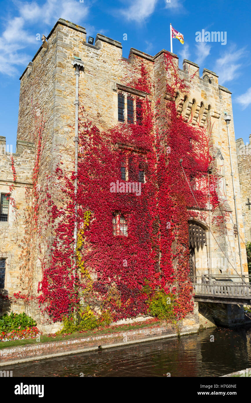 Hever Castle & moat, former home of Anne Boleyn, clad with red autumnal ...