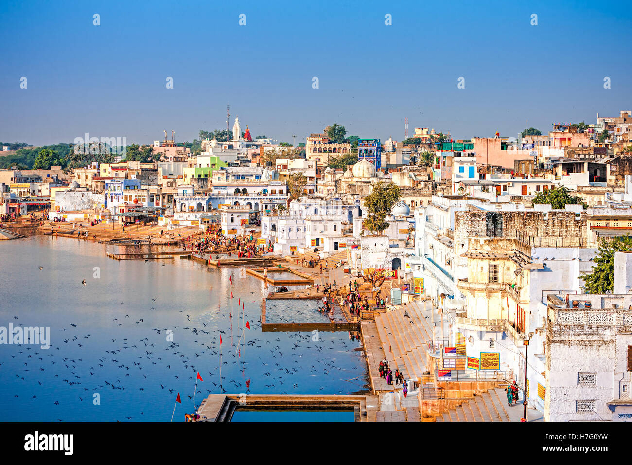 Hindu pilgrims bathing in sacred Lake Pushkar (Sarovar) on ghats ...