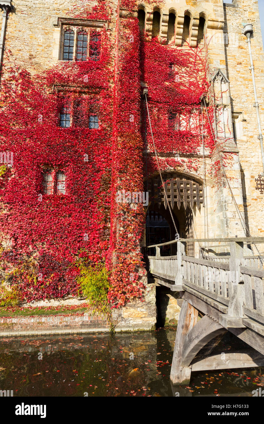 Hever Castle clad with red autumnal virginia creeper: Blue sky / sunny ...