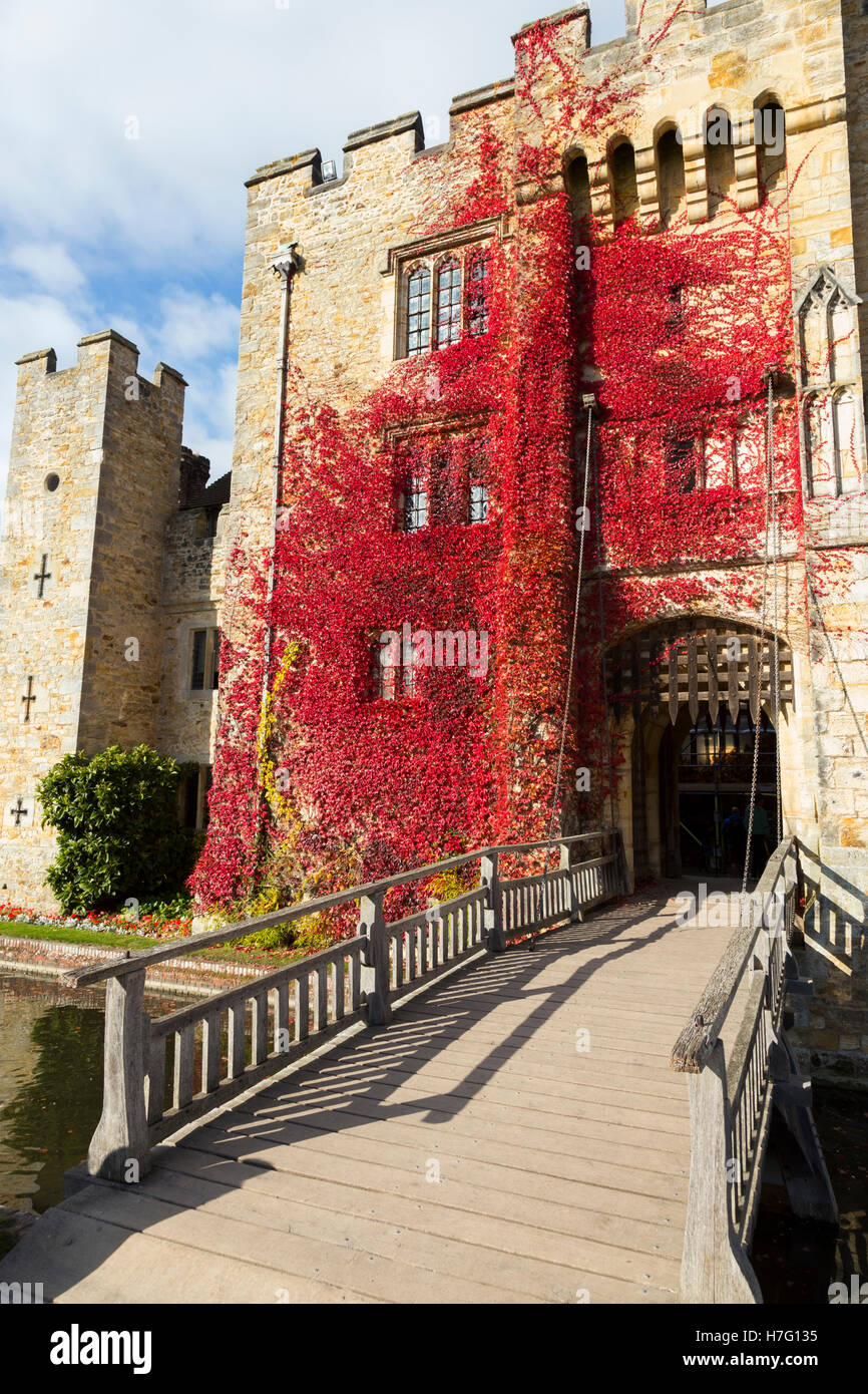Hever Castle clad with red autumnal virginia creeper: Blue sky / sunny ...