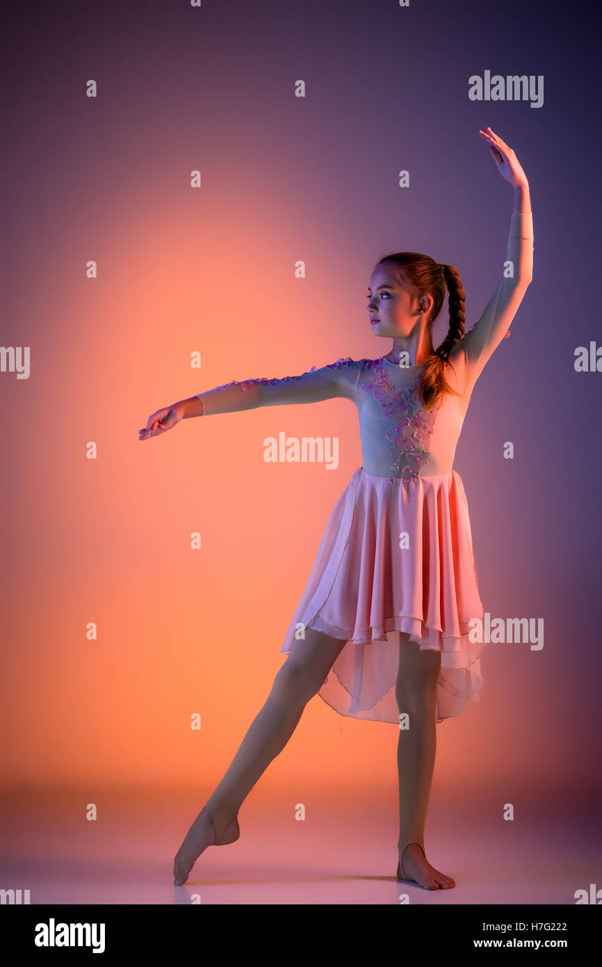 The female teen modern ballet dancer on orange studio background Stock ...