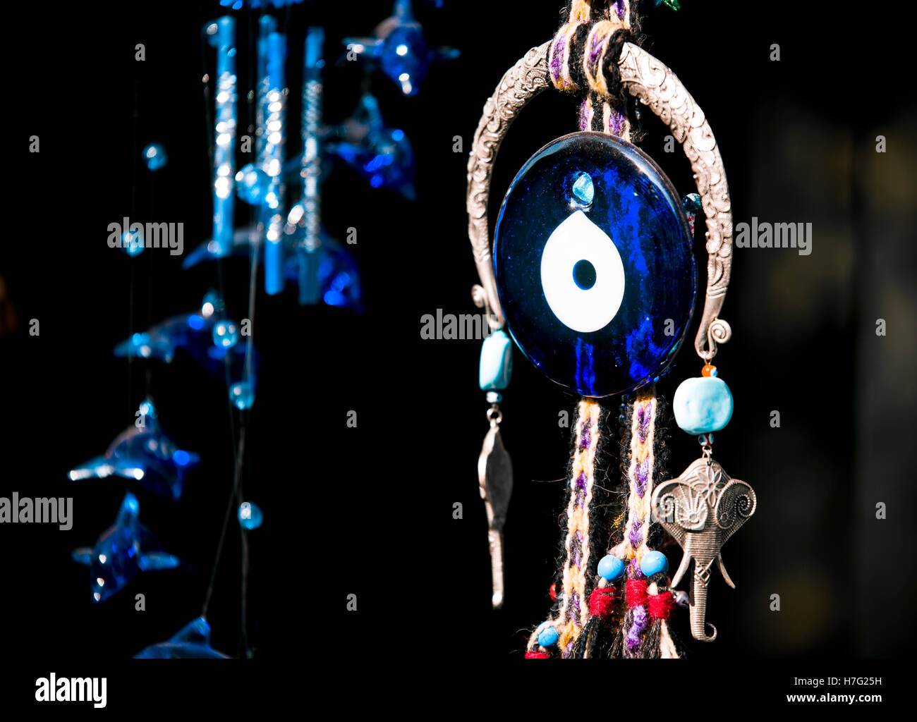 Blue amulet hanging on a black background Stock Photo - Alamy