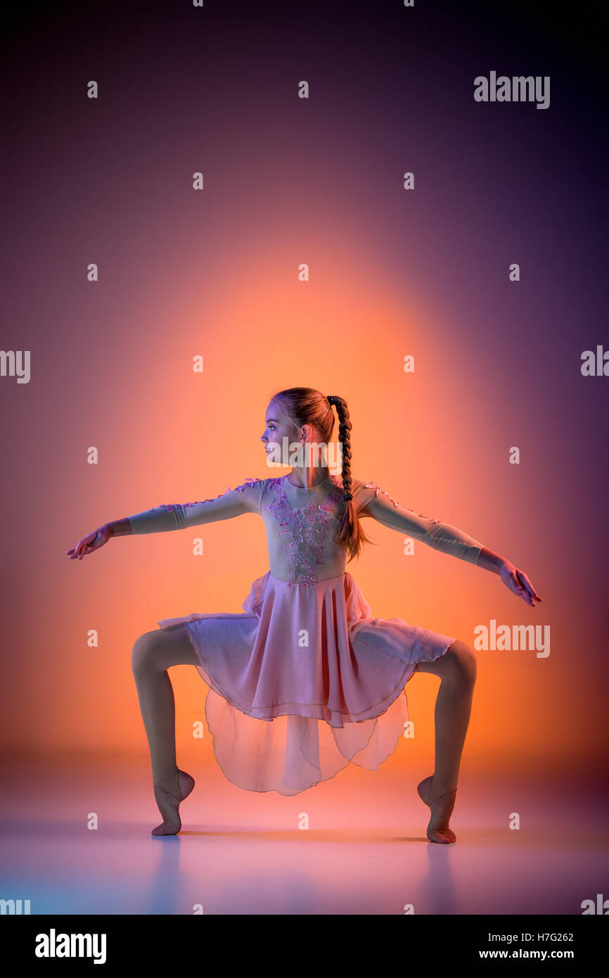 The female teen modern ballet dancer on orange studio background Stock ...