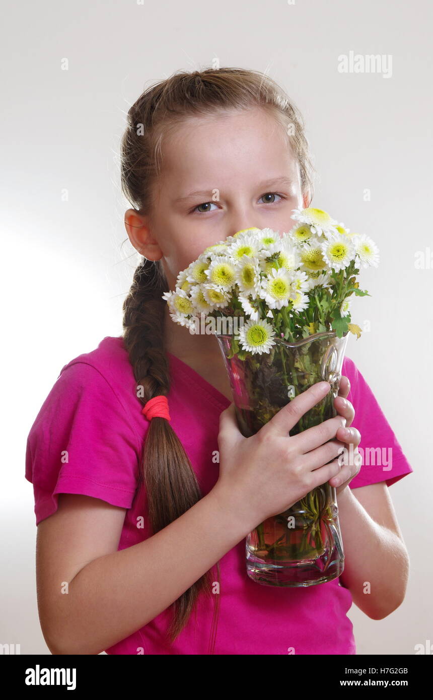 pretty girl with flowers in vase Stock Photo - Alamy