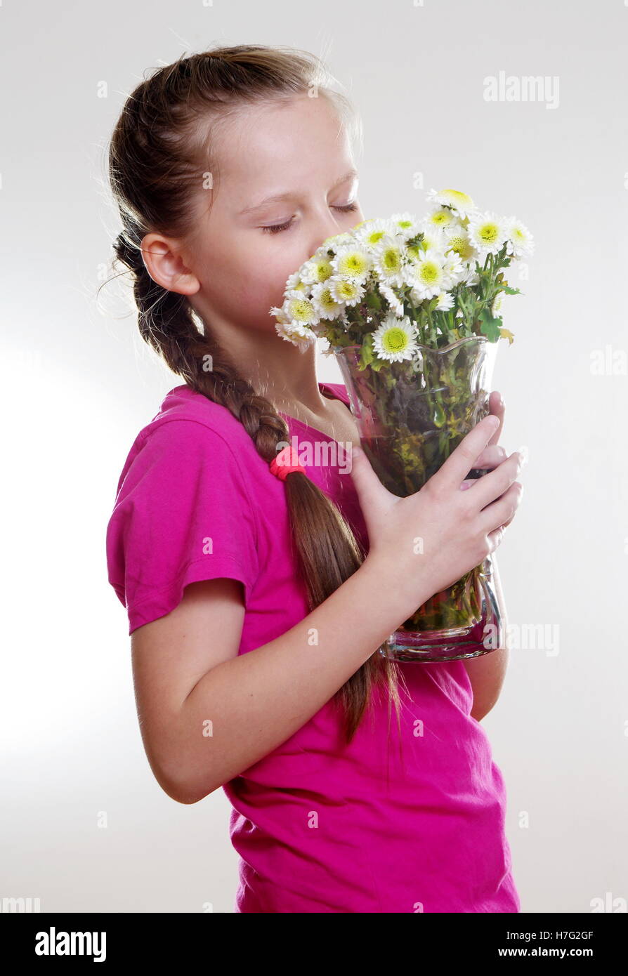 pretty girl with flowers in vase Stock Photo - Alamy