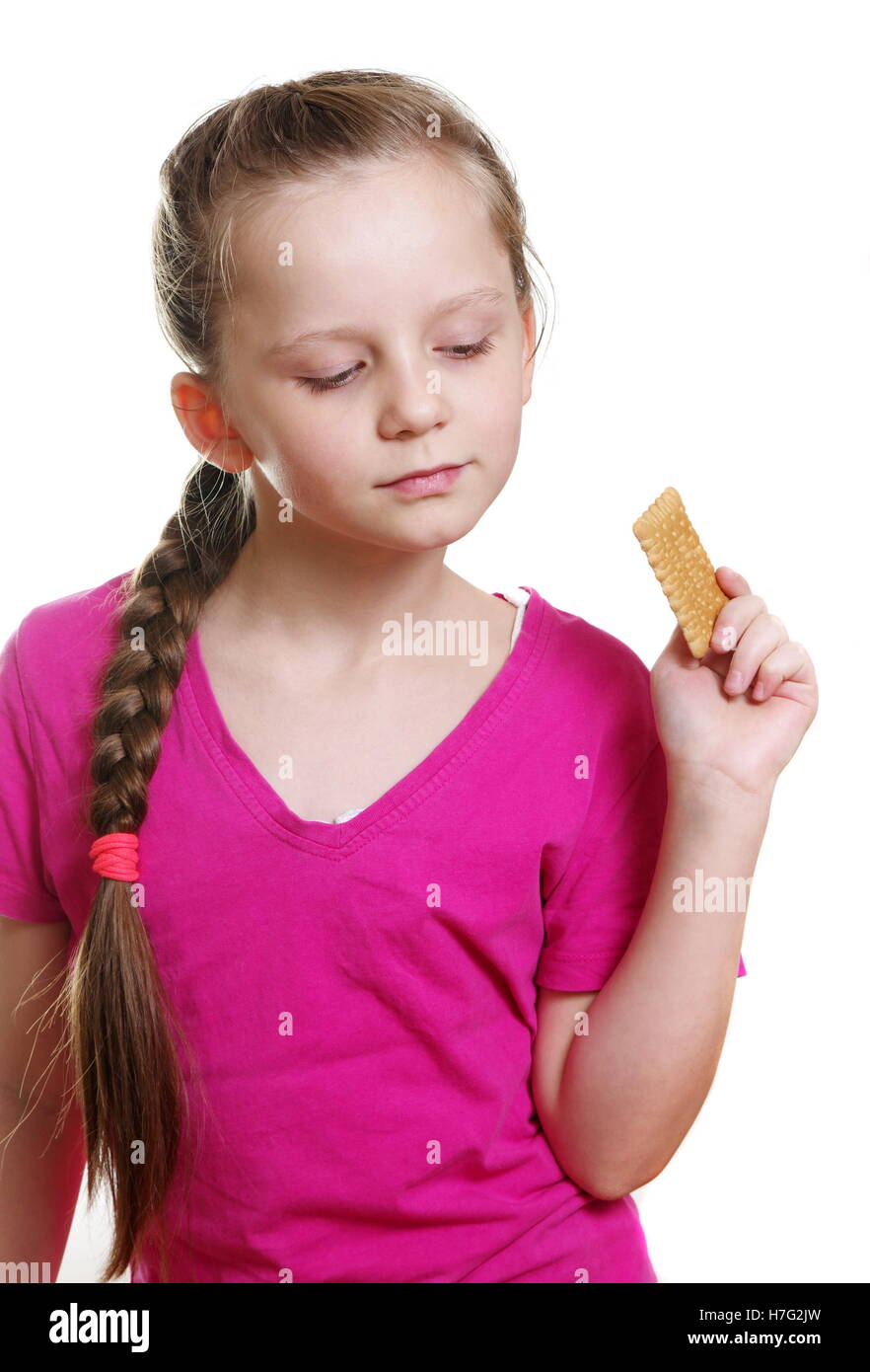 pretty girl eating bisquit Stock Photo - Alamy
