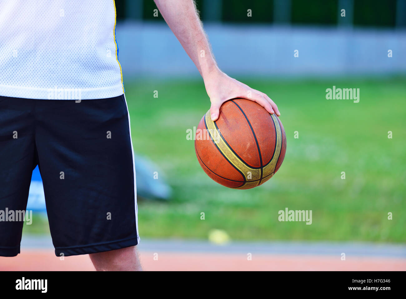 Young Streetball player with basketball ball outdoors Stock Photo - Alamy