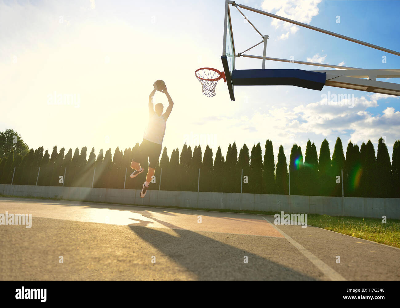 A young basketball player flying towards the rim for a slam dunk Stock ...