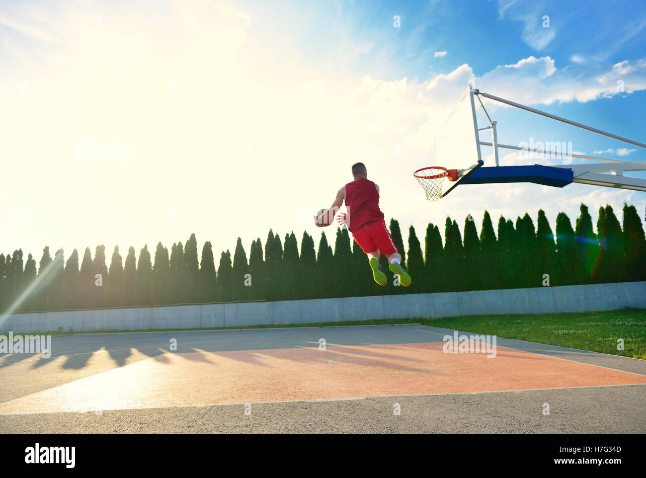 A young basketball player flying towards the rim for a slam dunk Stock ...