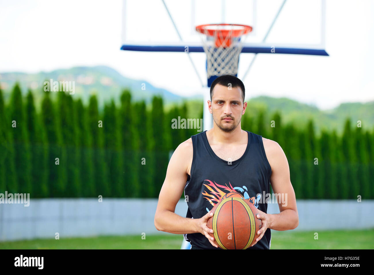 Basketball player with ball at the outdoors basket court Stock Photo ...