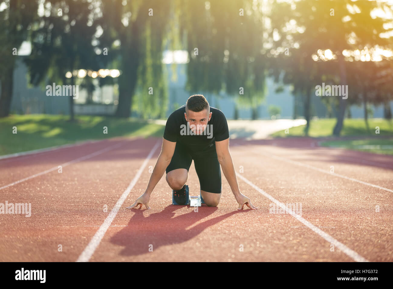 Detailed view of a sprinter getting ready to start. Selective focus ...