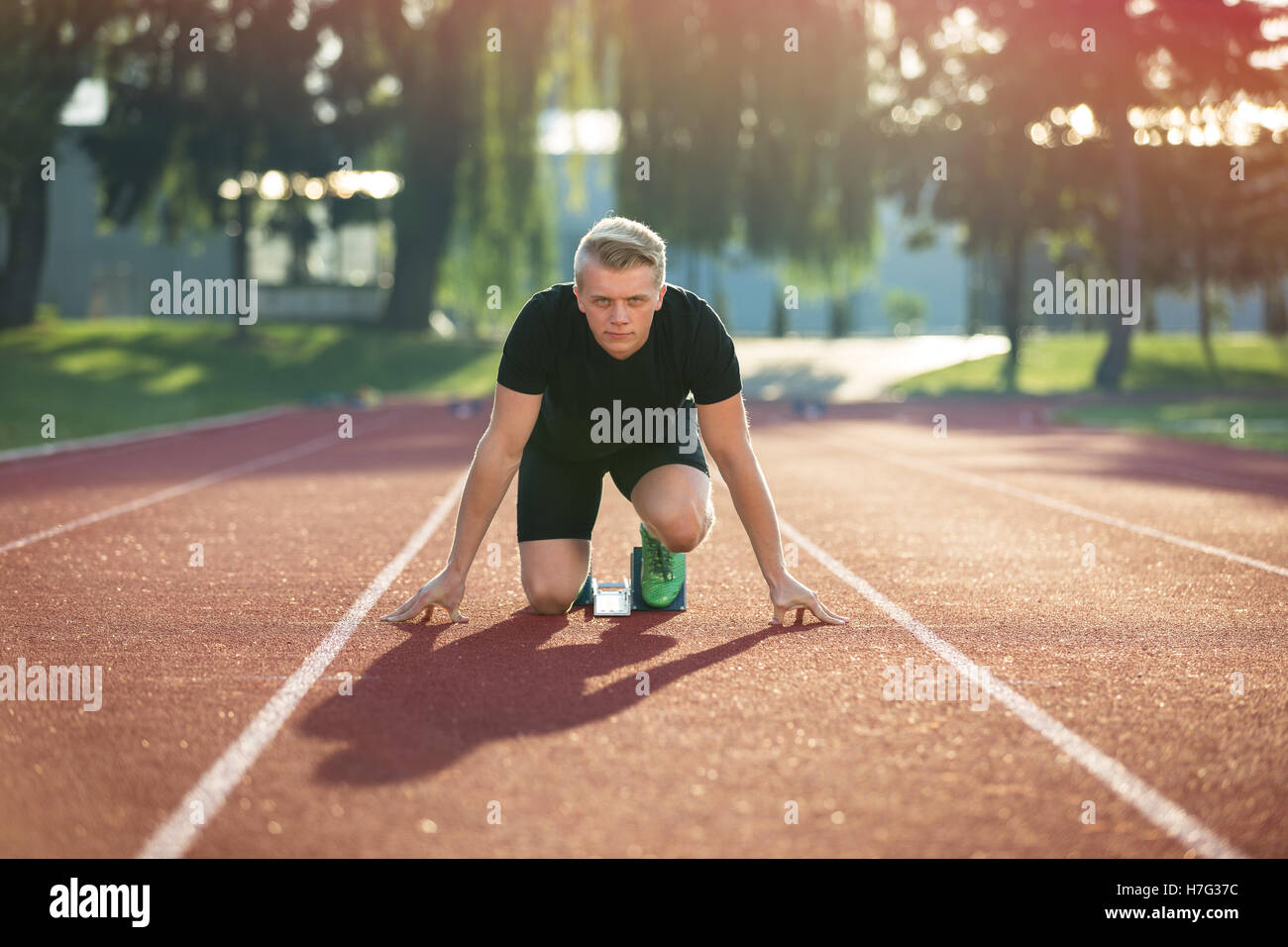Detailed view of a sprinter getting ready to start. Selective focus ...