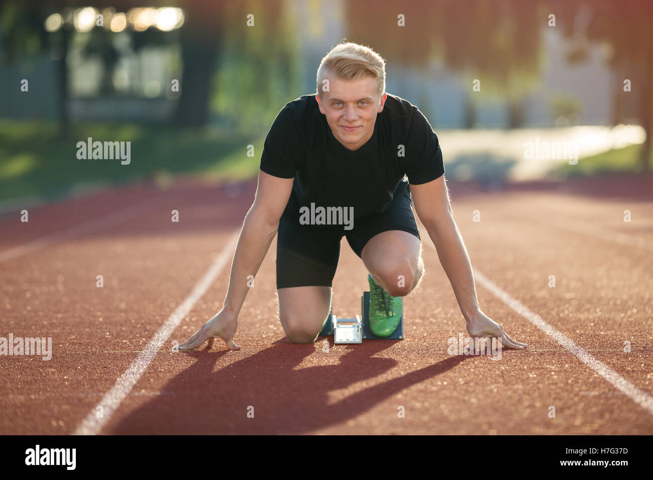 Detailed view of a sprinter getting ready to start. Selective focus ...