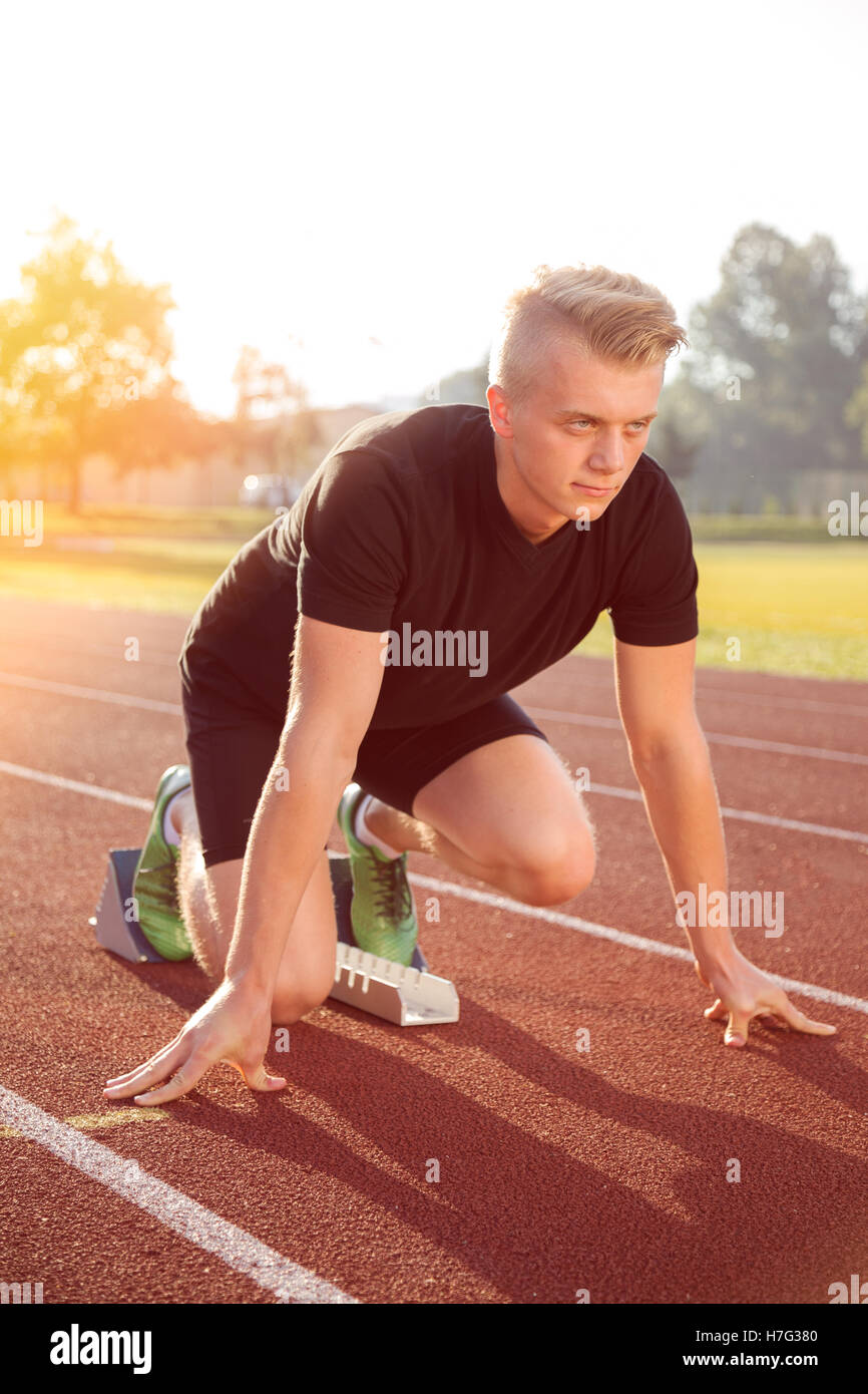 Athletic man starting jogging in sun rays Stock Photo - Alamy