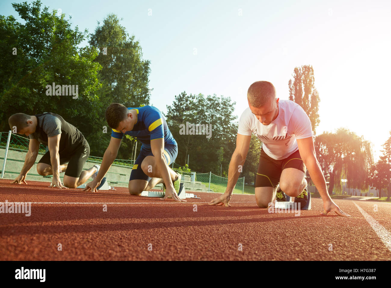 Athletic man starting jogging in sun rays Stock Photo - Alamy