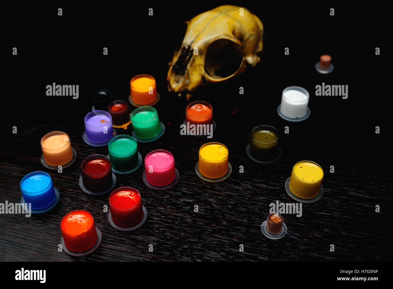 Caps for tattoo ink with colored on the background of a skull Stock ...