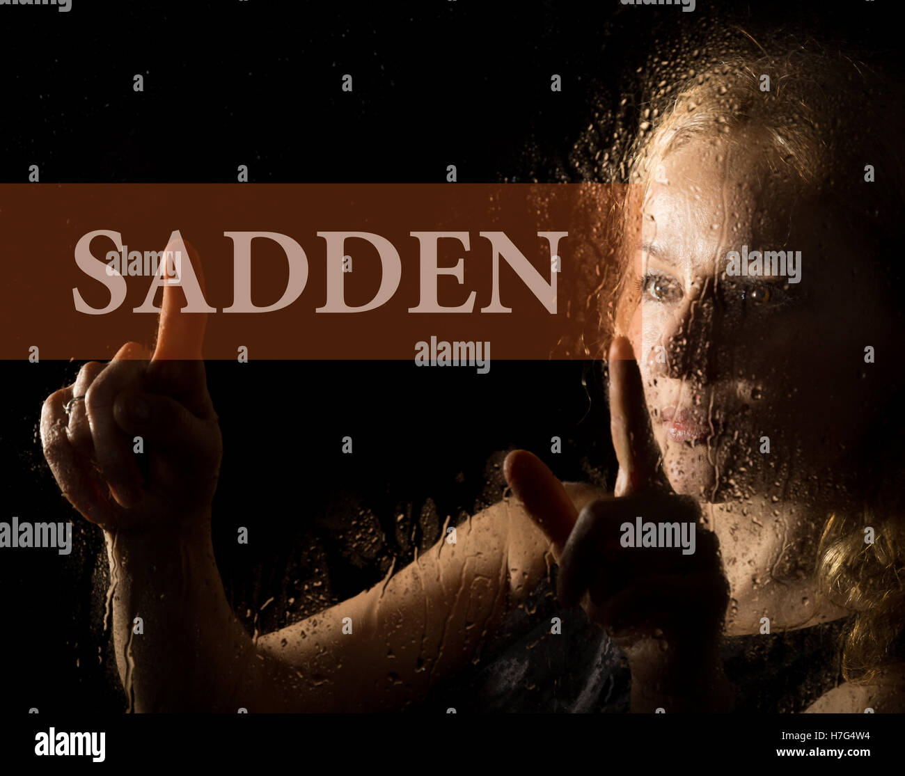 sadden written on virtual screen. hand of young woman melancholy and ...